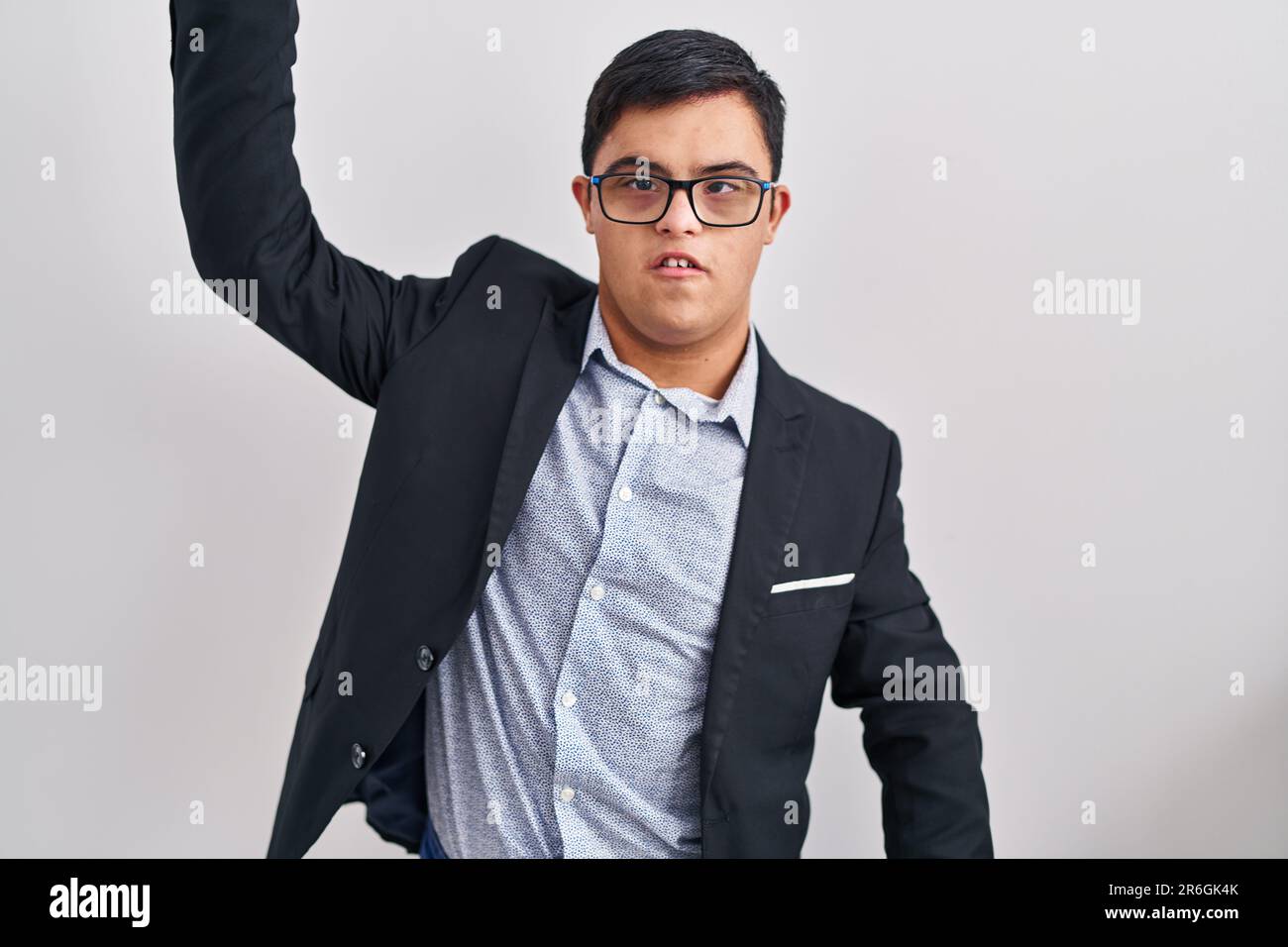 Young hispanic man with down syndrome wearing business style angry and ...