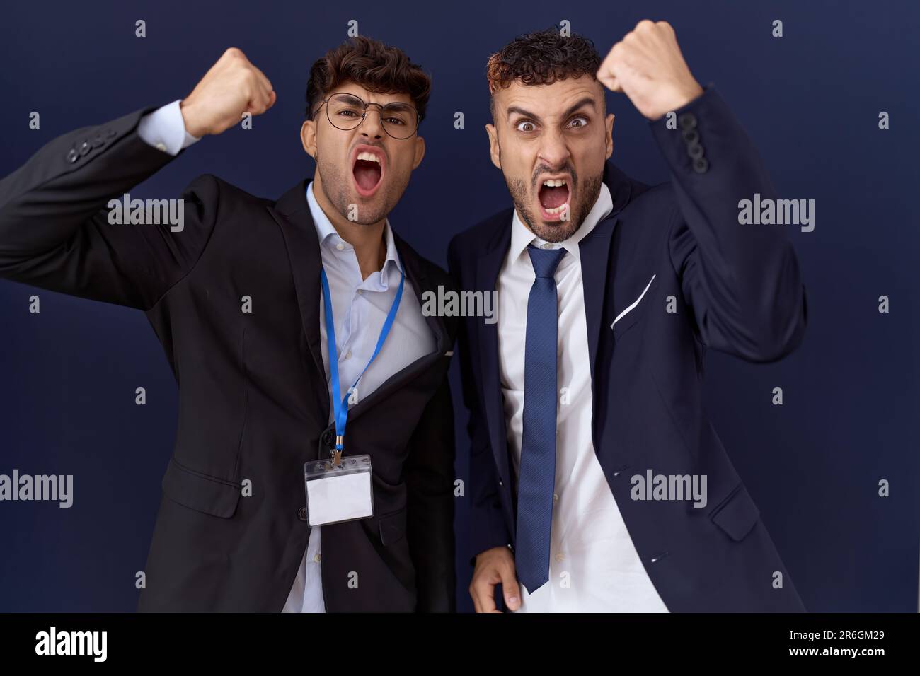 Two hispanic business men wearing business clothes angry and mad ...