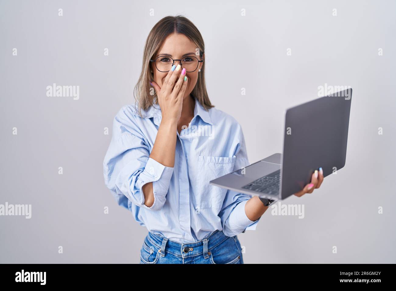 Young woman working using computer laptop laughing and embarrassed ...