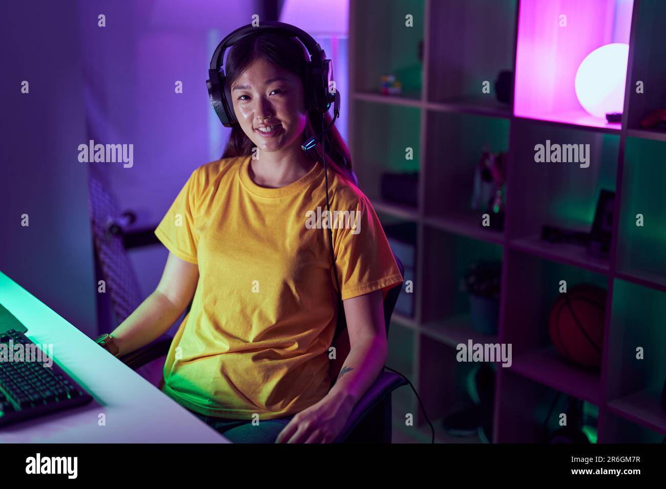 Chinese woman streamer smiling confident using computer at gaming room ...