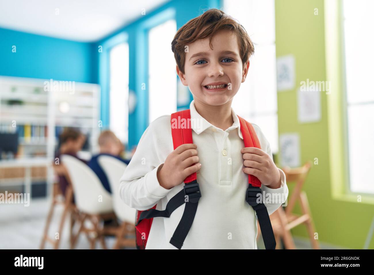 Adorable caucasian boy student smiling confident standing at classroom ...