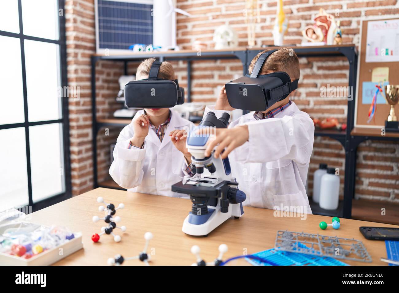 Adorable boys scientist student using virtual reality glasses at laboratory classroom Stock ...
