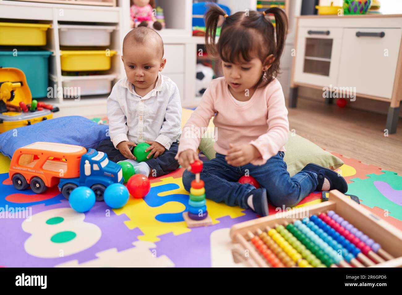 Boy girl playing balls hi-res stock photography and images - Alamy
