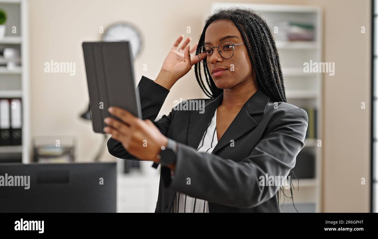 African american woman business worker using touchpad at office Stock ...