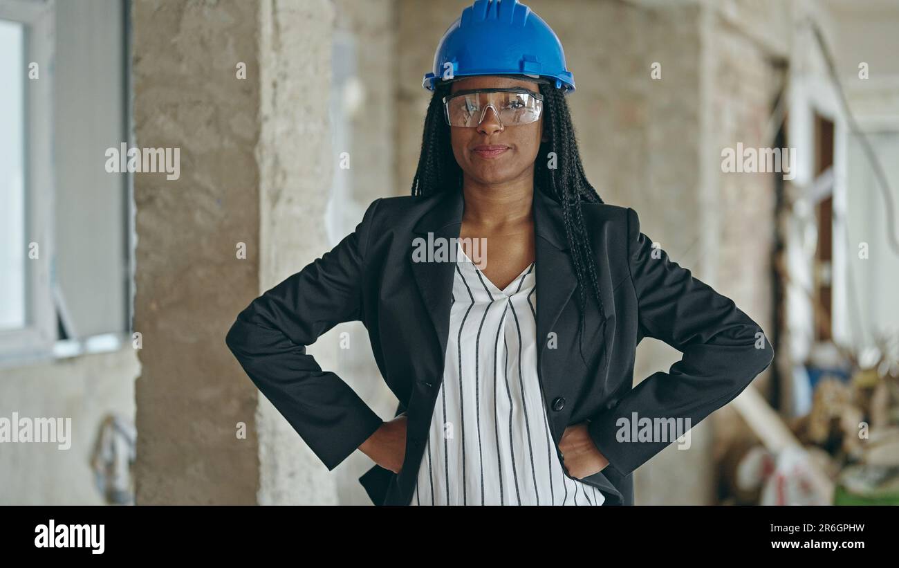 African american woman architect standing with relaxed expression at ...
