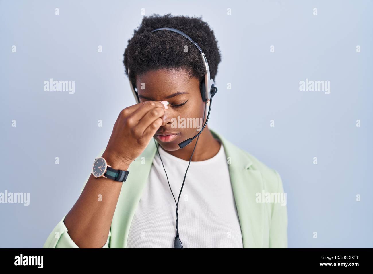 African american woman wearing call center agent headset tired rubbing ...