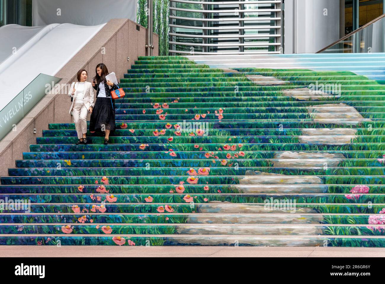 Two Office Workers Walking Down The Colourful Steps Of An Office ...