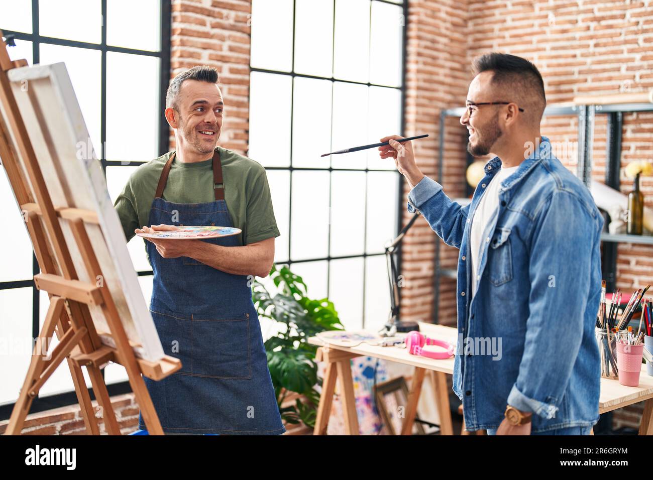 Two men artists smiling confident drawing at art studio Stock Photo - Alamy