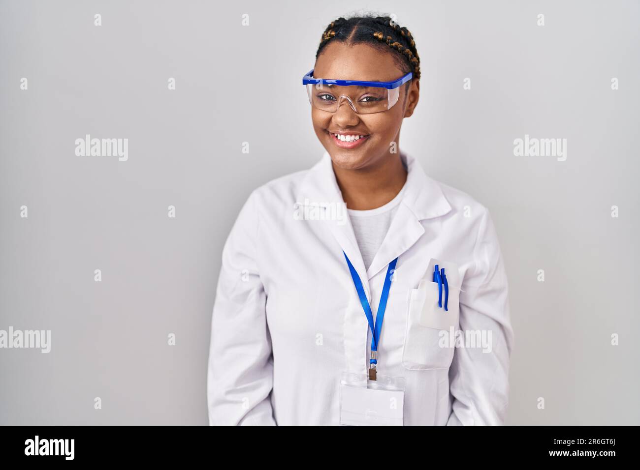African american woman with braids wearing scientist robe looking ...