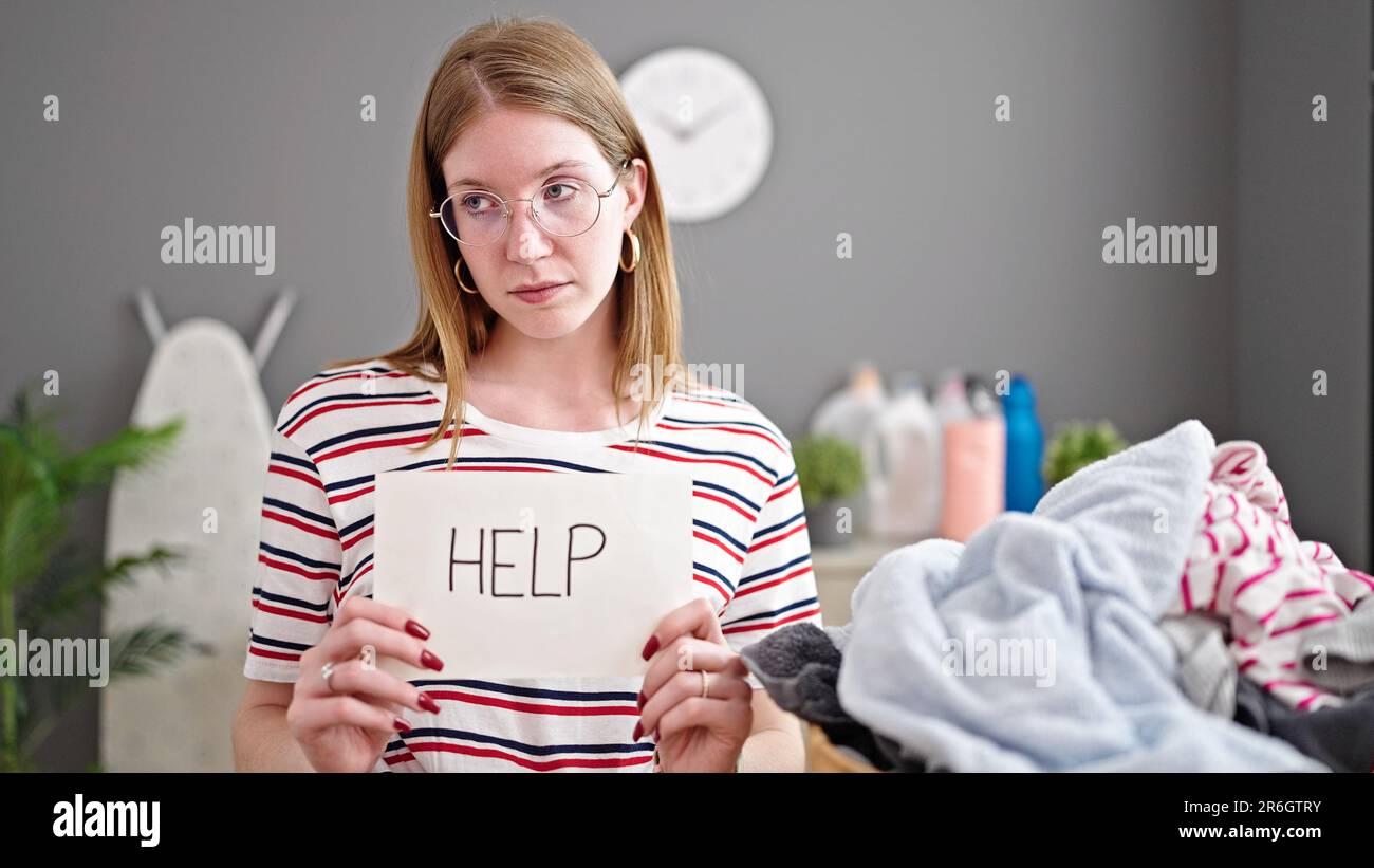 Young blonde woman asking for help at laundry room Stock Photo - Alamy