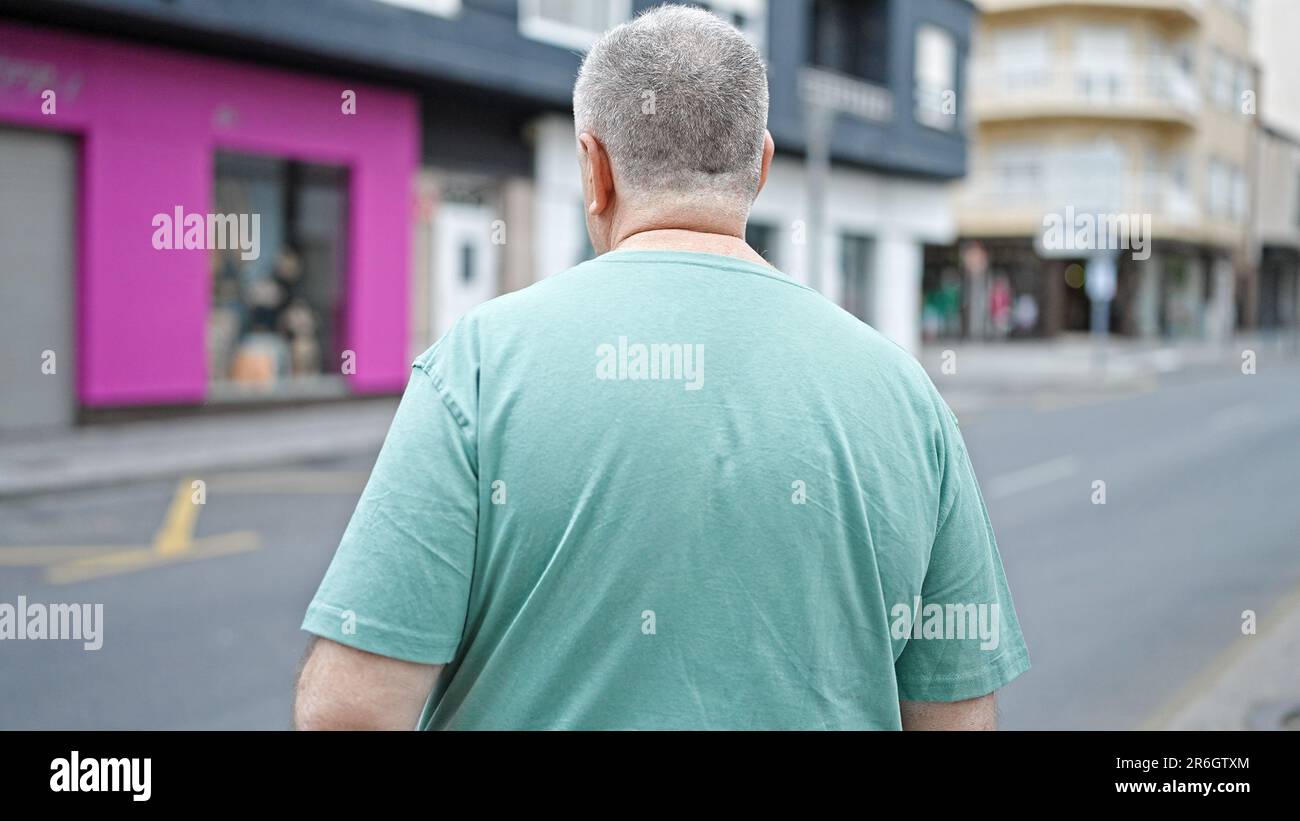 Middle age grey-haired man standing backwards at street Stock Photo - Alamy