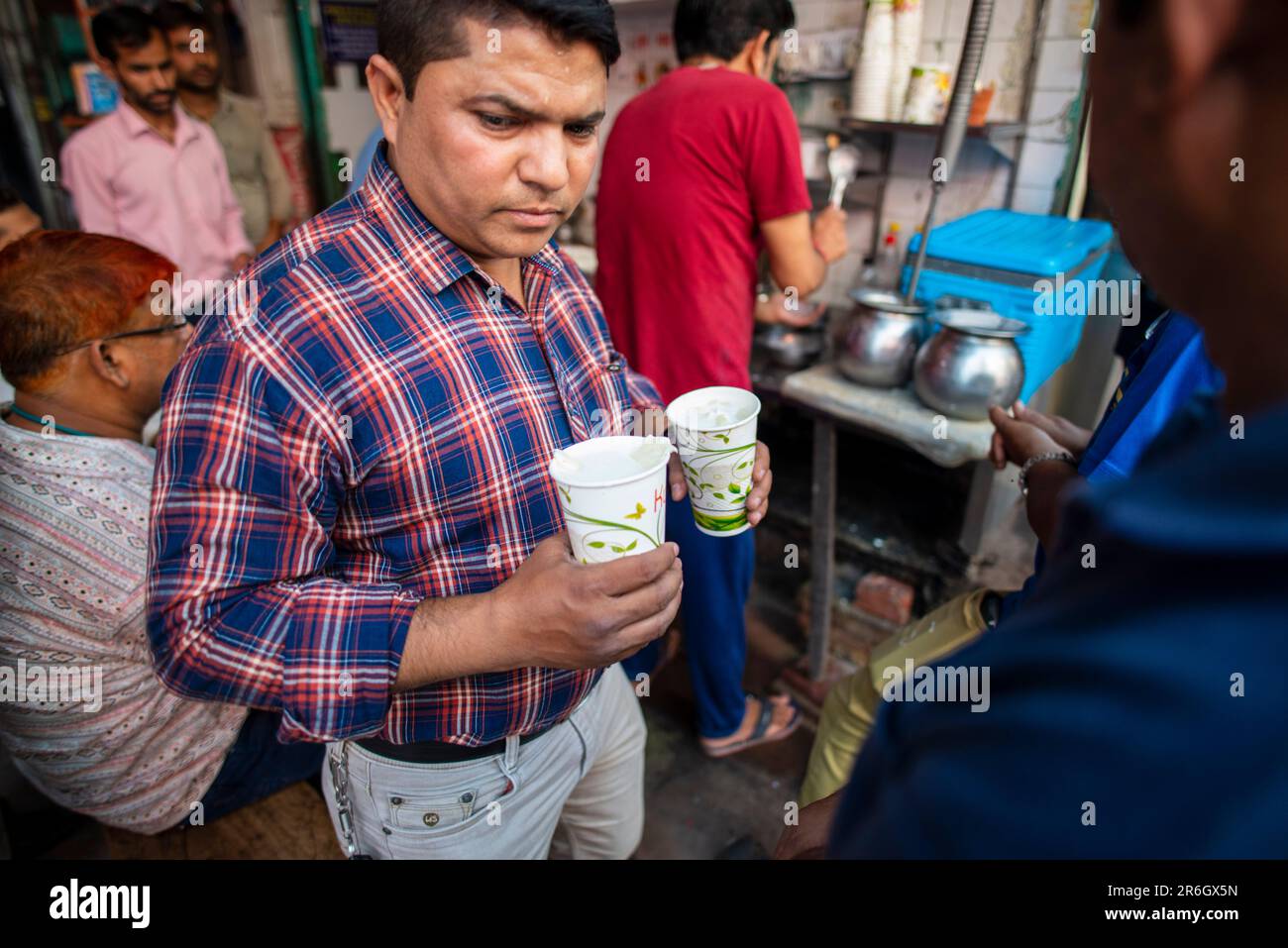 A man about to drink glass of Lassi (made with yogurt and sugar) in ...