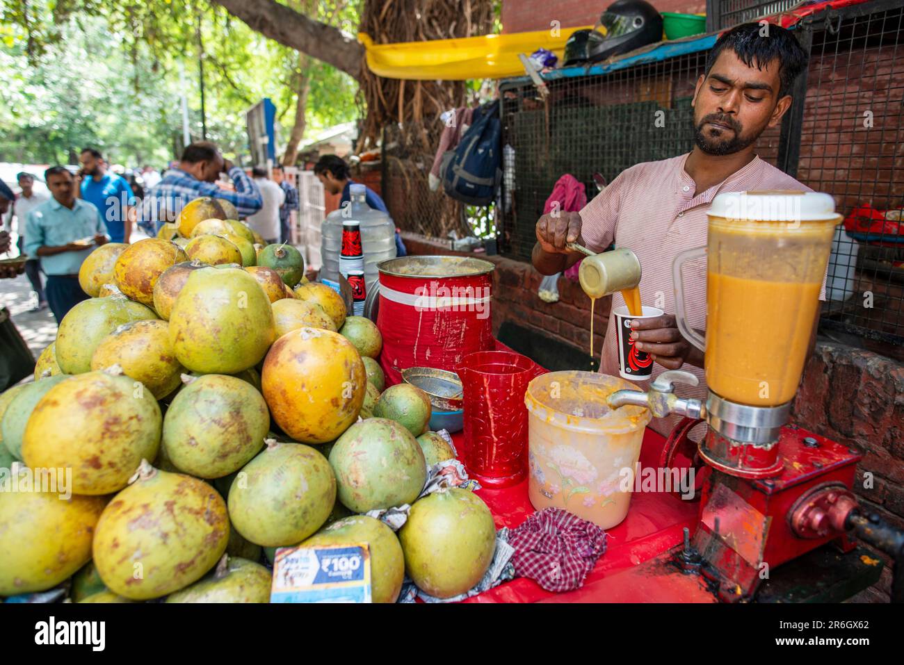 A man seen serving Beal juice (juice of Aegle marmelos fruit with ...