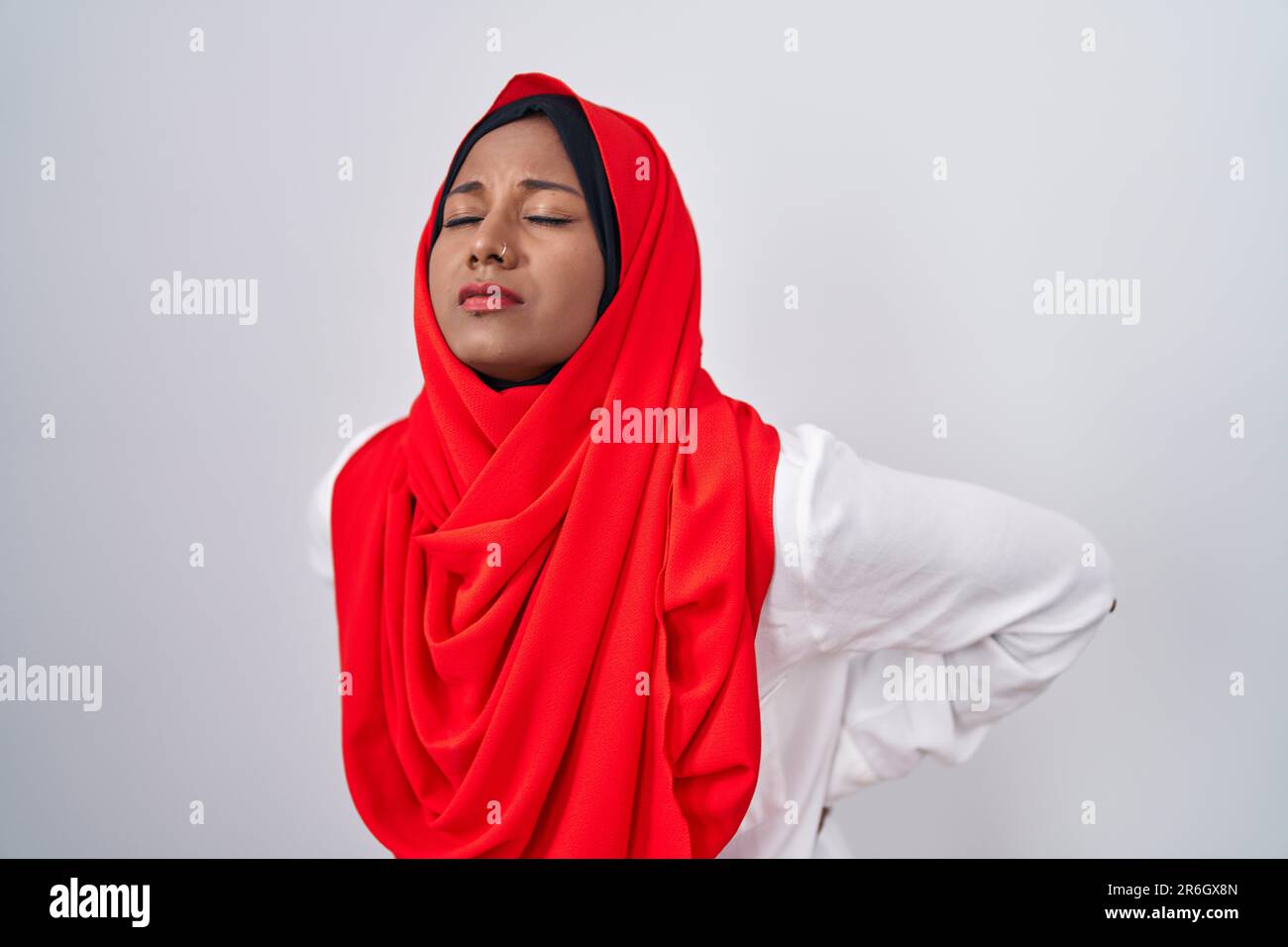 Young arab woman wearing traditional islamic hijab scarf suffering of ...