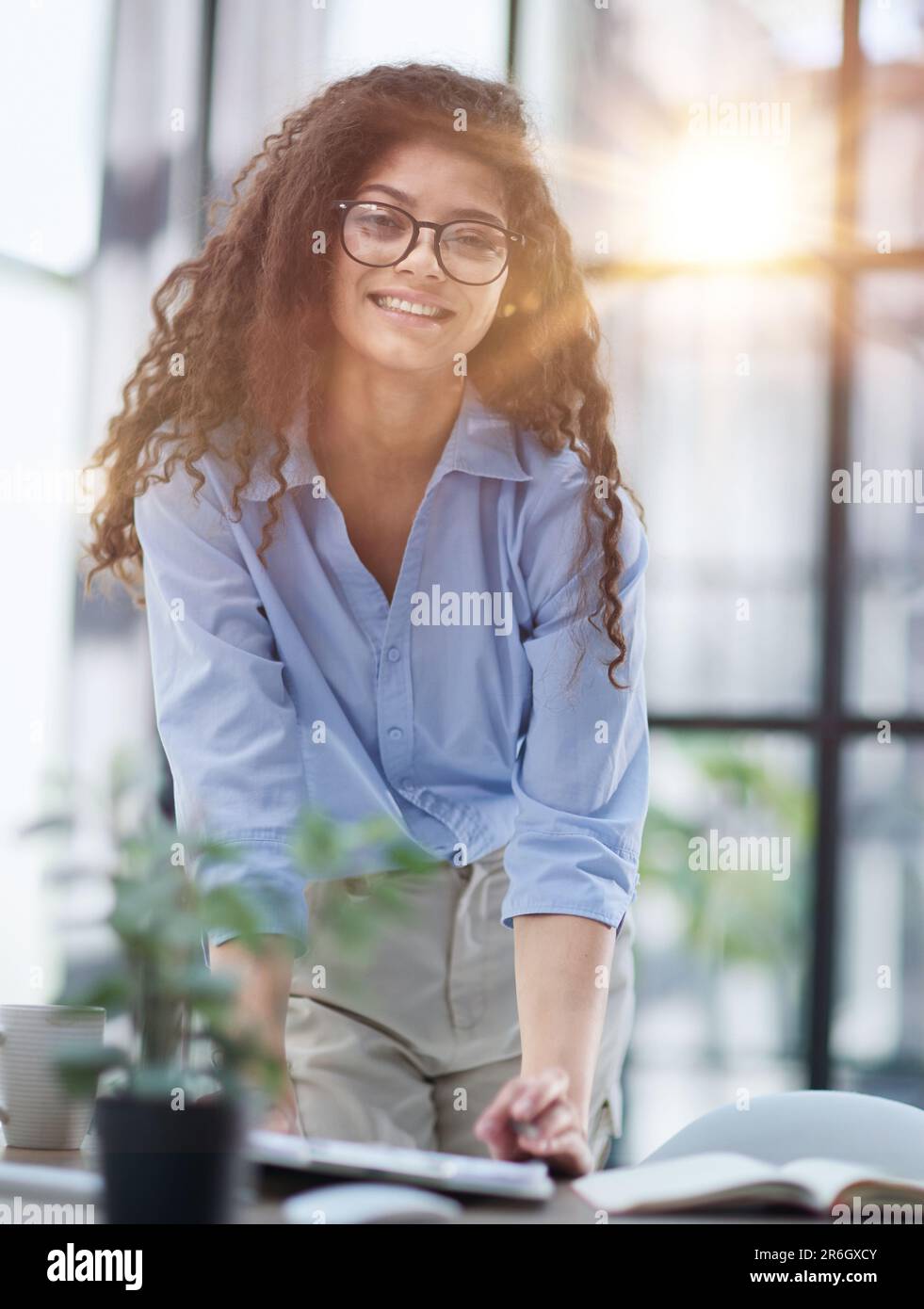 A young woman makes a report in the office. Woman writing notes for ...