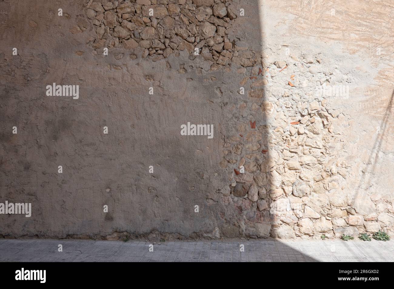 Sun shadow on old stone building wall background. Light and shadow ...