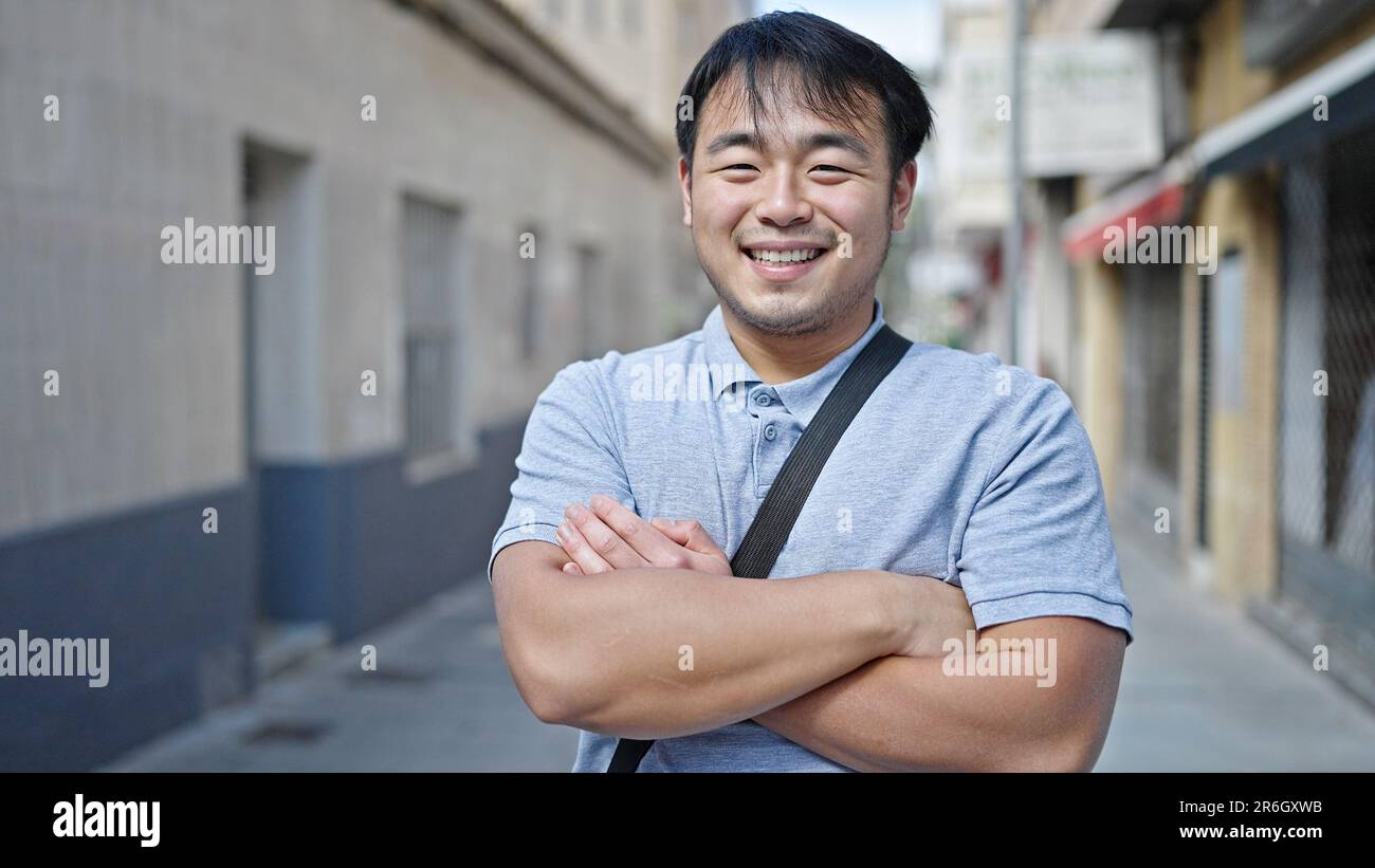 smiling confident standing with arms crossed gesture at street Stock ...