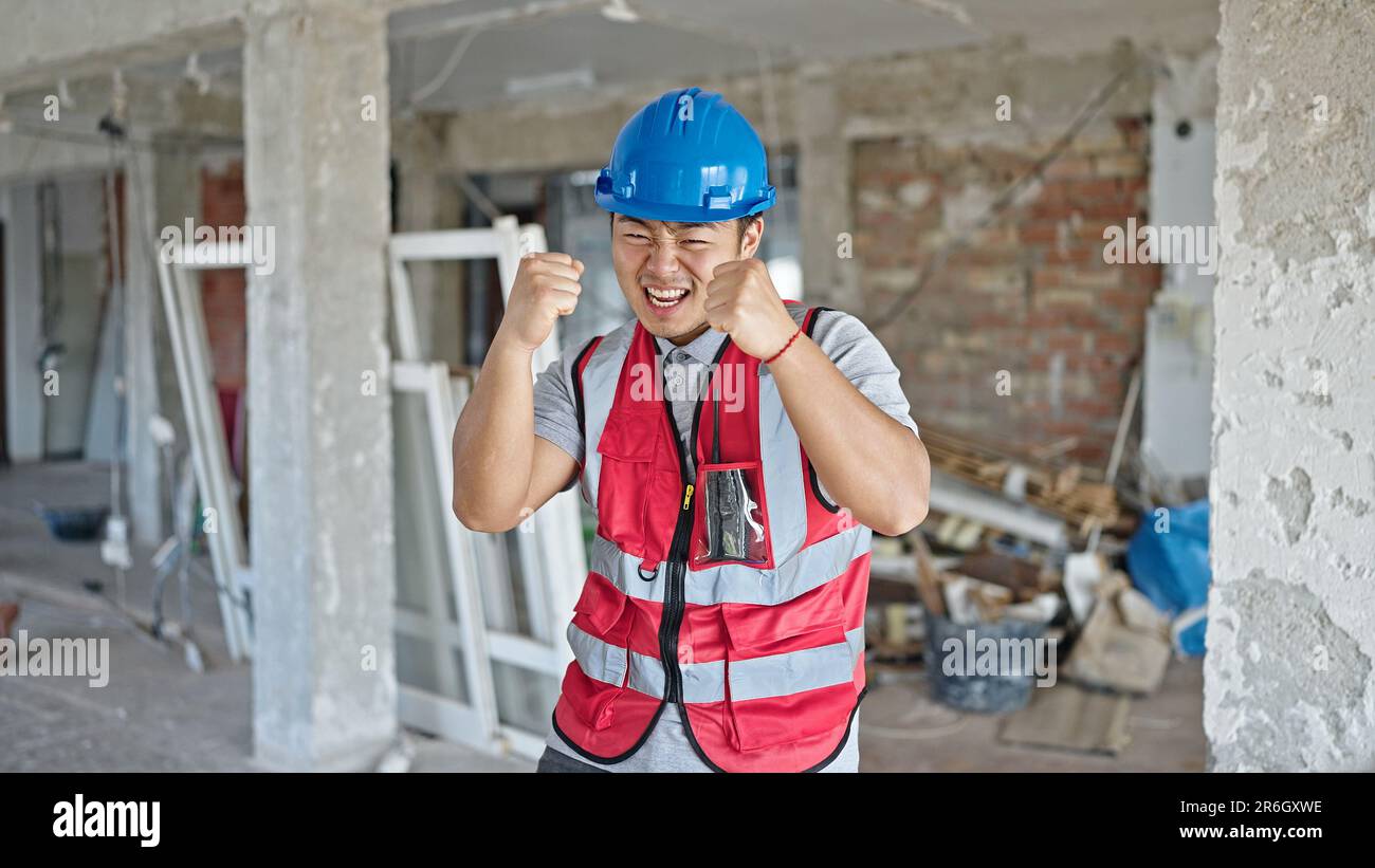 builder smiling with winner expression at construction site Stock Photo ...