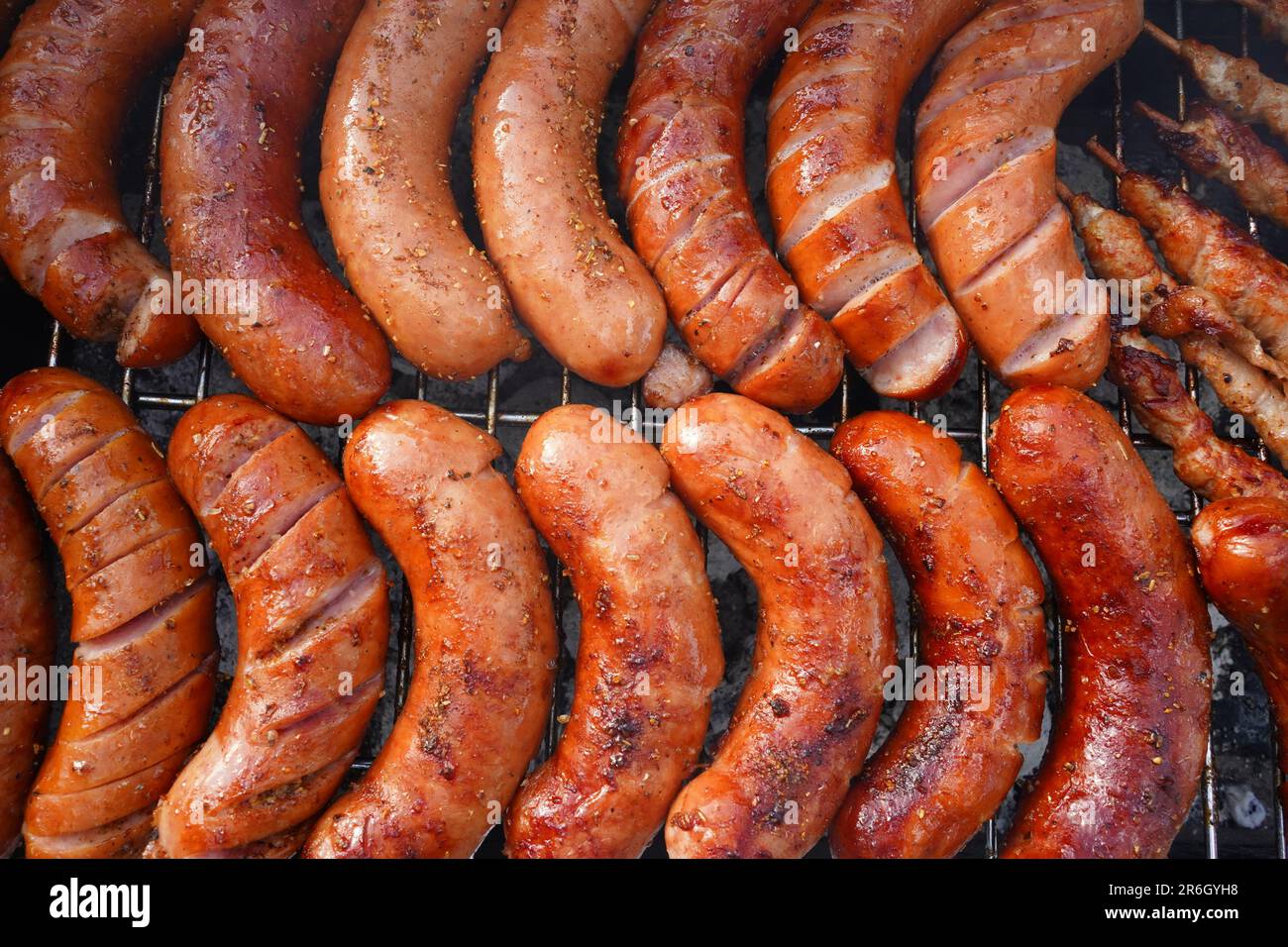 Grilled sausages on barbecue top view. Barbecue in the garden. Grilling ...