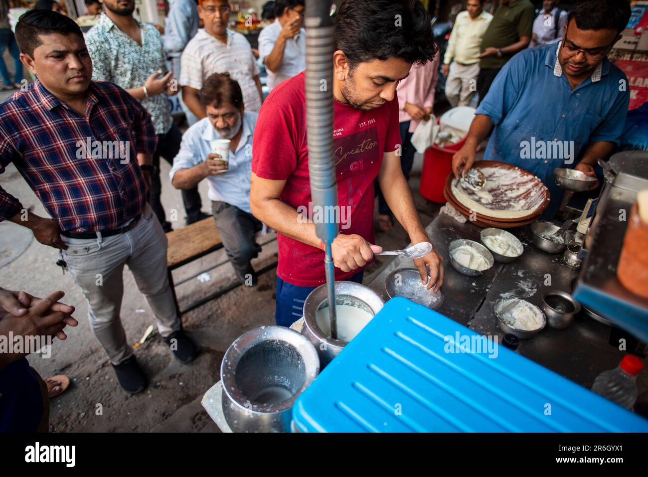 New Delhi, India. 8th June, 2023. A man seen making Lassi (made with ...