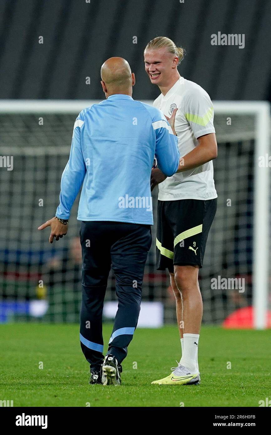 Istanbul, Turkey. 09th June, 2023. Pep Guardiola manager of Manchester City talks to Erling ...