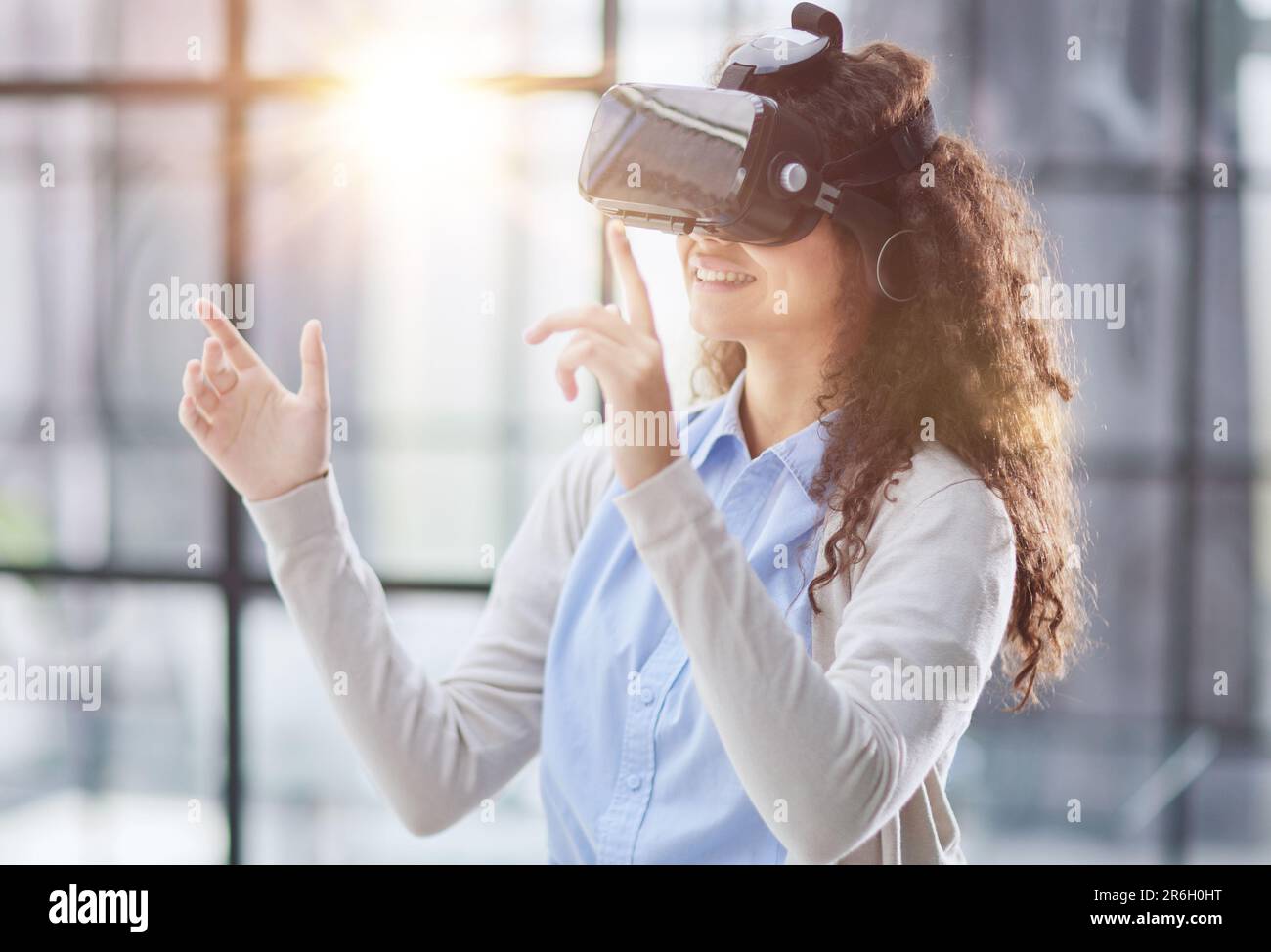 Girl trying to touch objects in virtual reality Stock Photo - Alamy