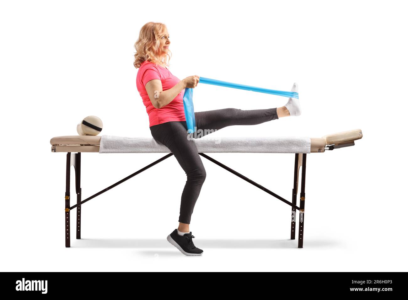 Female patient exercising with a resistance band isolated on white ...