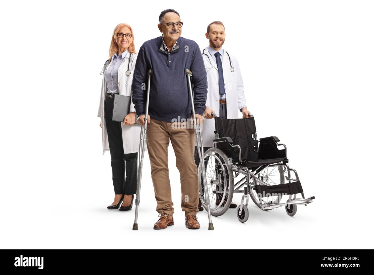 Doctors with wheelchair standing behind a patient with crutches ...