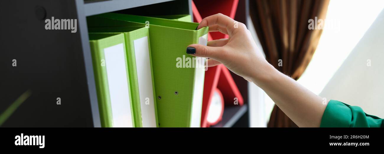 Hand taking book off shelf hi-res stock photography and images - Alamy