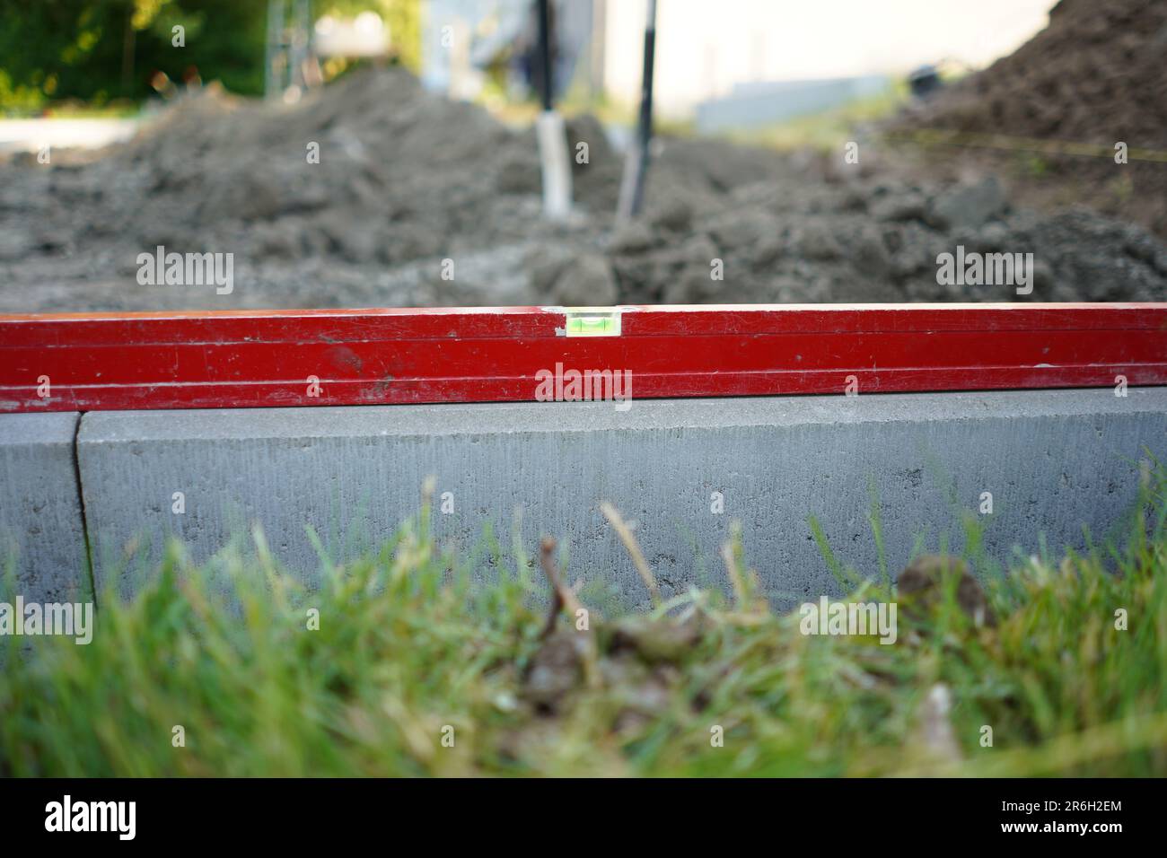 Level on the concrete kerb. Leveling on the construction site. Work ...