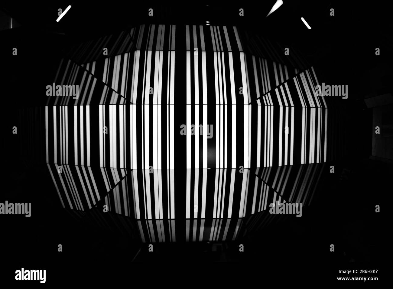 A close-up of a decorative light fixture with multiple colorful objects ...