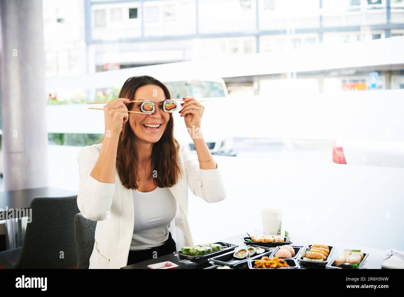 Young woman eating business lunch in sushi restaurant Stock Photo - Alamy