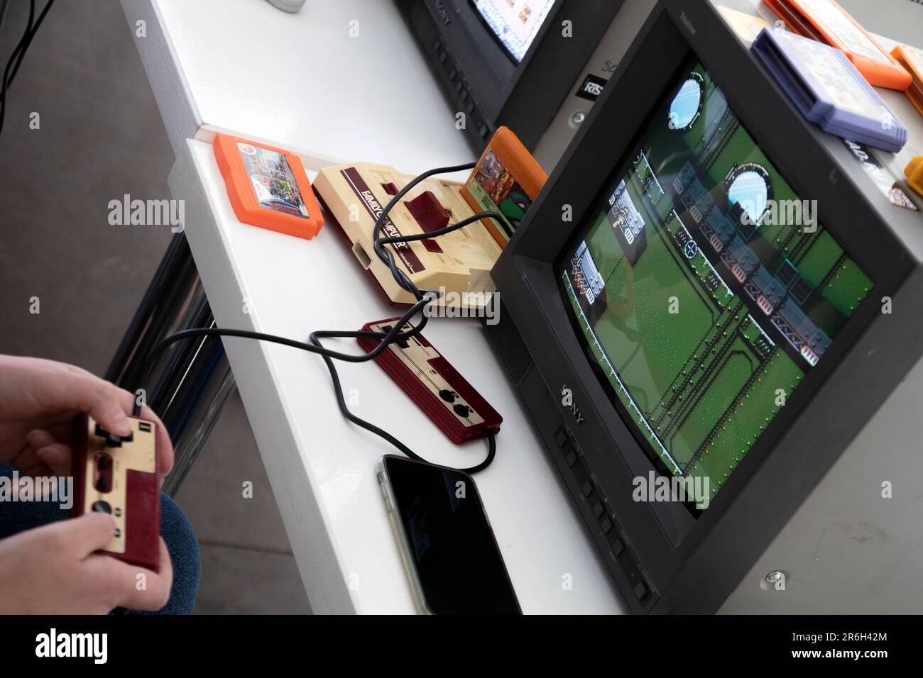 A man plays at a Nintendo Entertainment System console (NES) in the ...