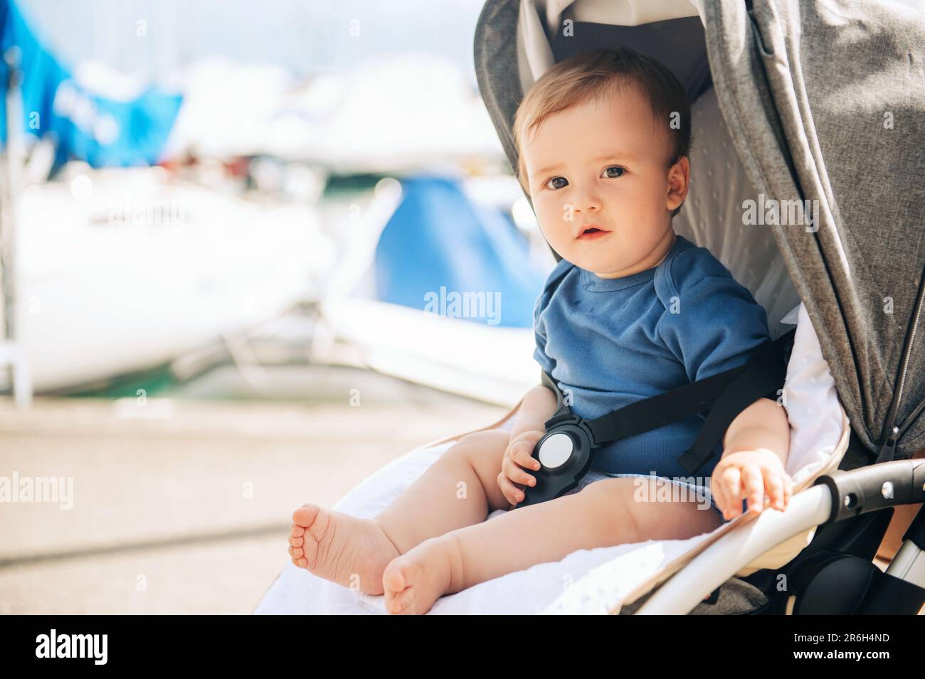 Outdoor portrait of adorable baby boy sitting in a stroller Stock Photo ...