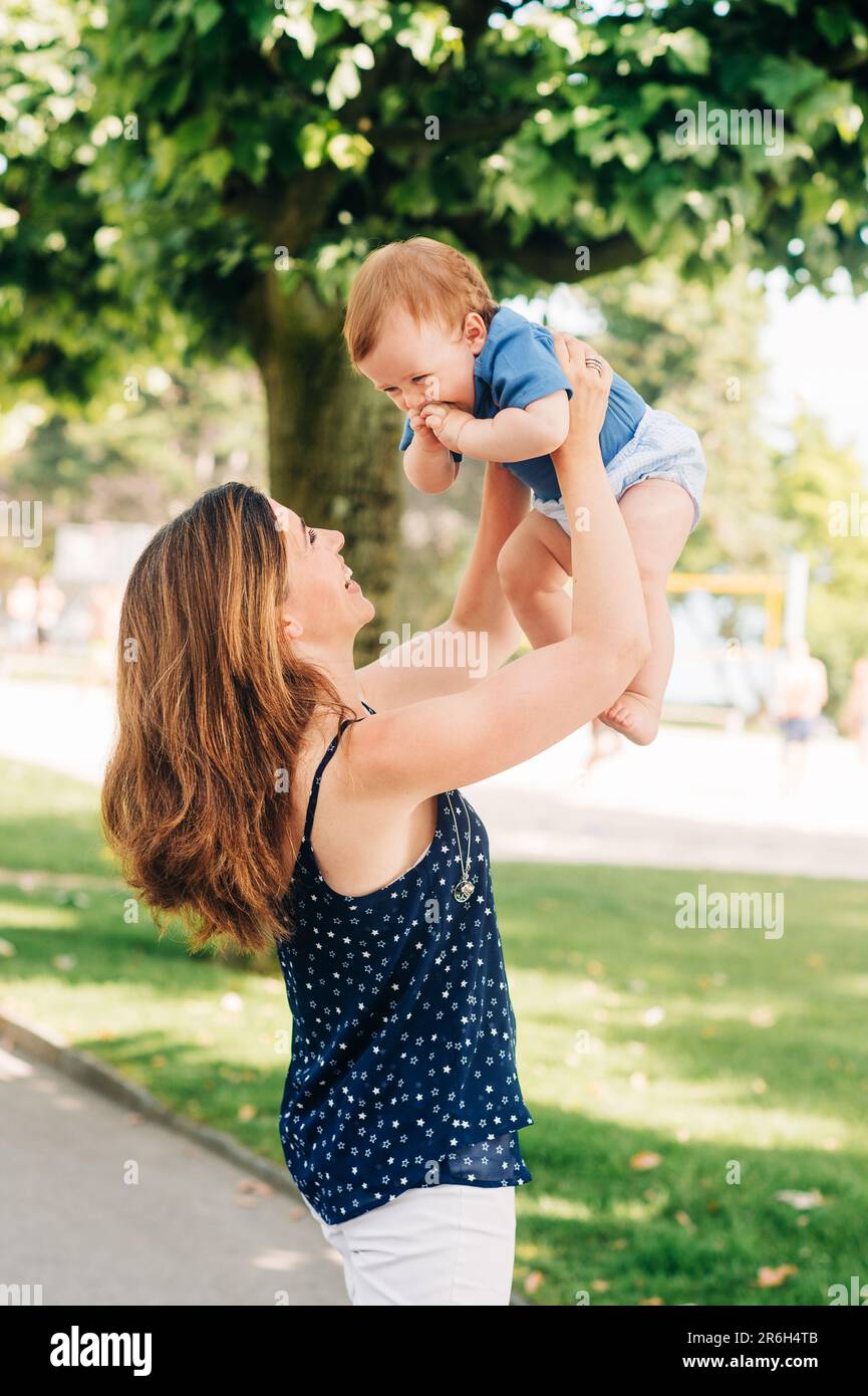 Mother lifting beautiful baby outdoor hi-res stock photography and images - Alamy