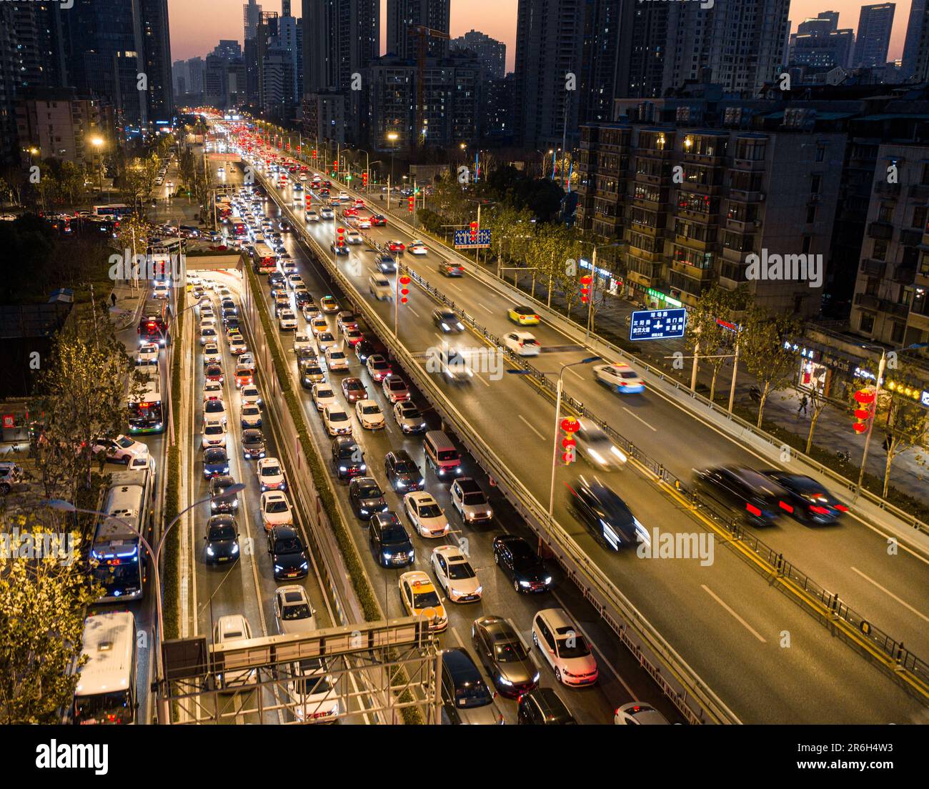 This image depicts a bustling street, with a variety of vehicles ...