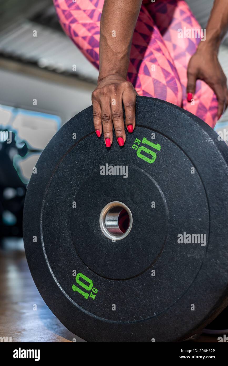 A female athlete is performing an exercise routine with a black gym ...