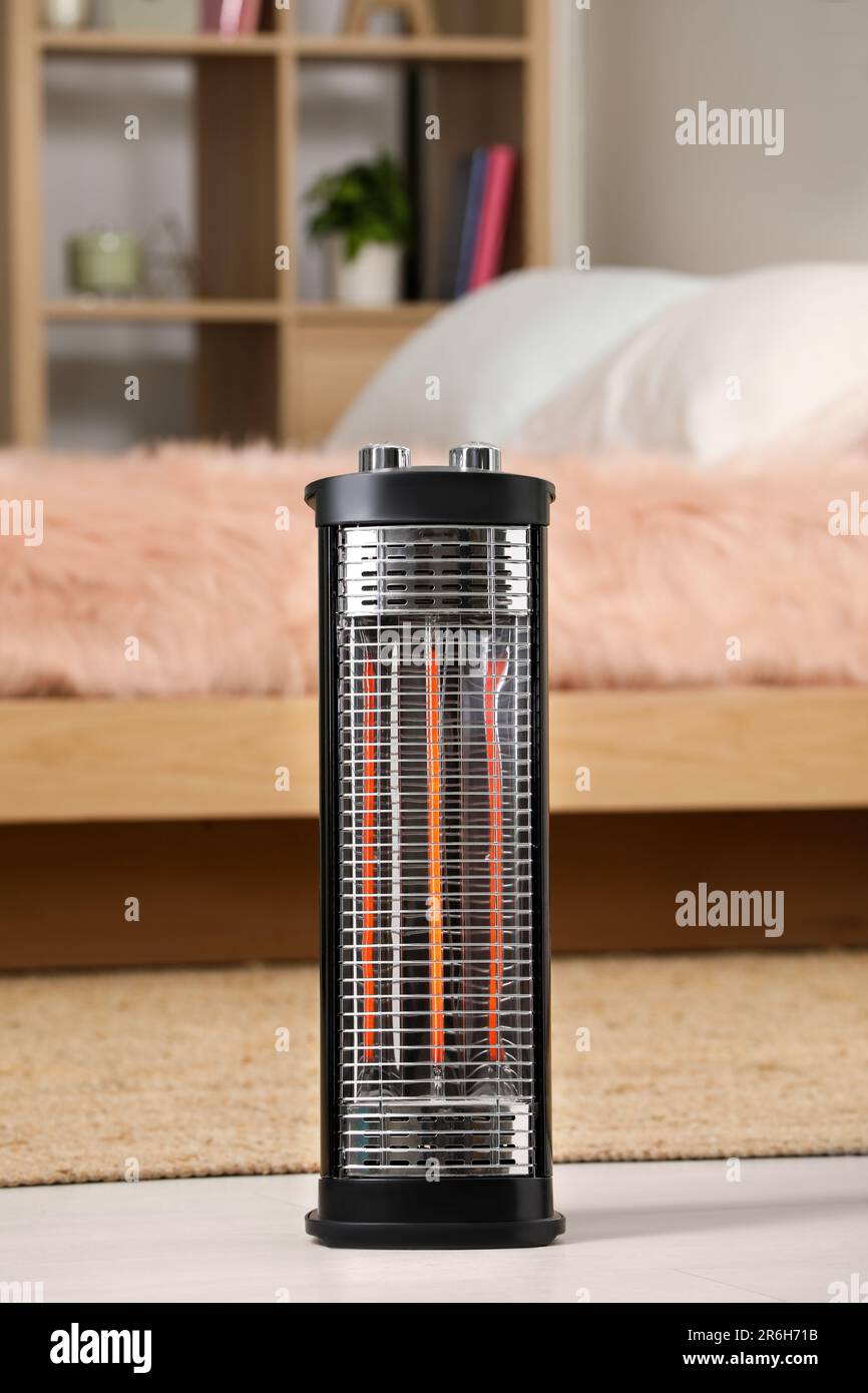 Modern infrared heater on floor in cozy room Stock Photo - Alamy