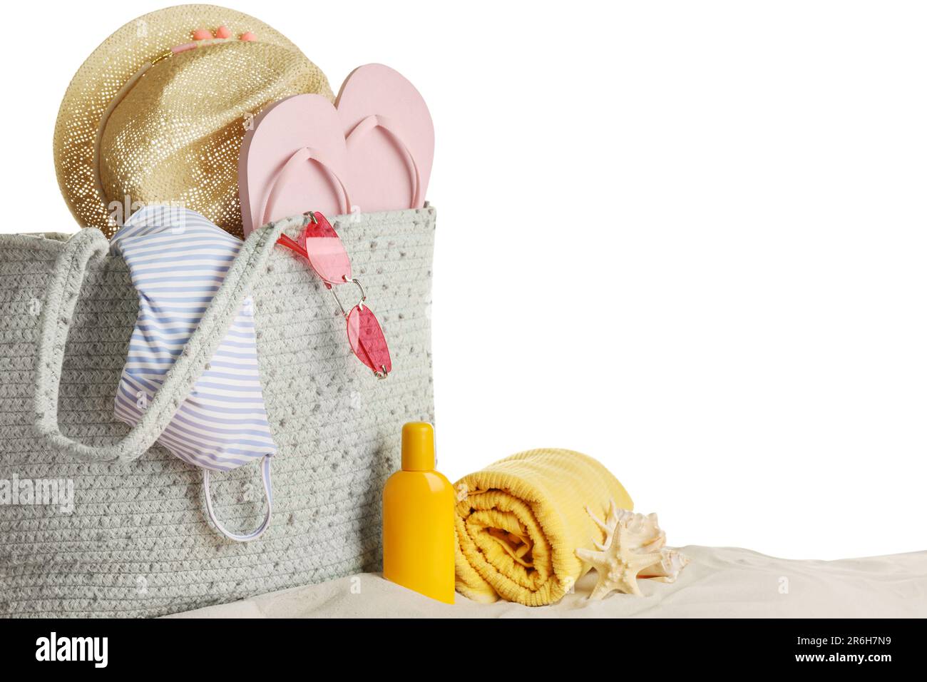 Bag with different beach objects on sand against white background Stock ...