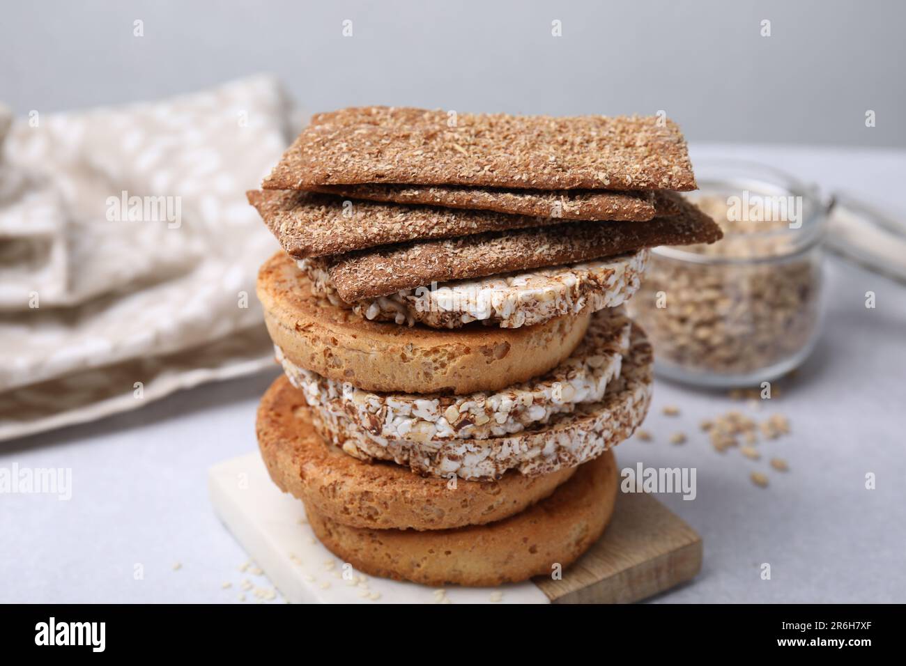 Stack of rye crispbreads, rice cakes and rusks on white table Stock ...