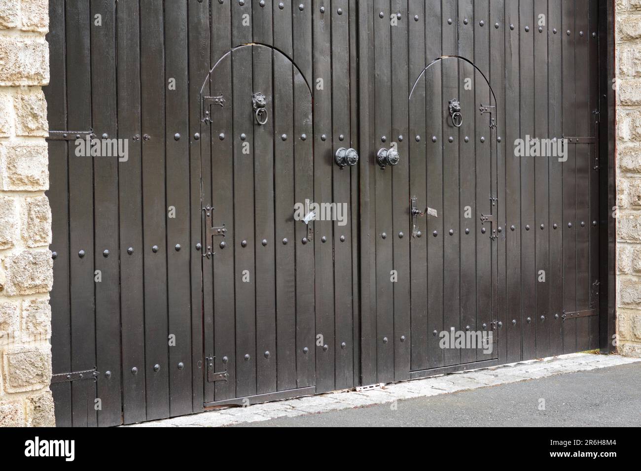 View of beautiful arched wooden doors outdoors Stock Photo - Alamy