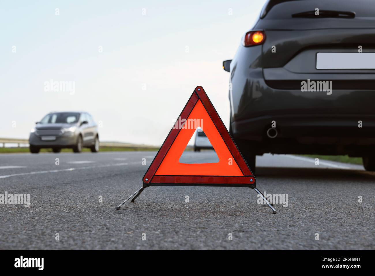 Emergency warning triangle near car on roadside. Tire puncture Stock ...