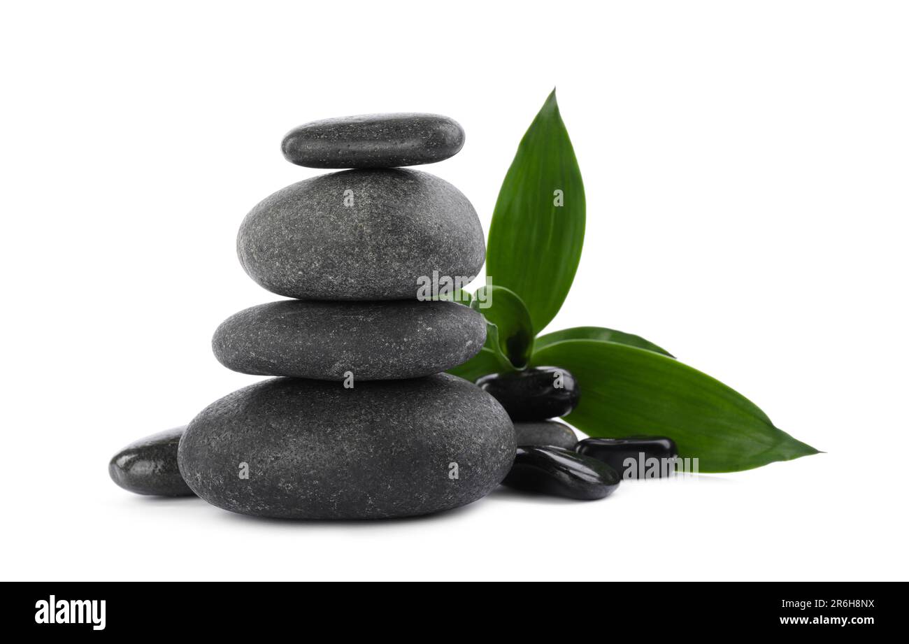 Spa stones with bamboo isolated on white Stock Photo - Alamy
