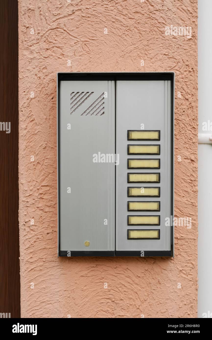 Modern intercom hanging on beige wall outdoors Stock Photo - Alamy