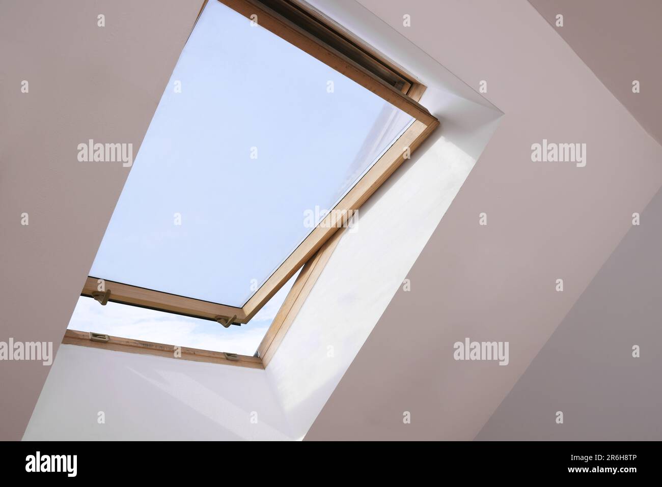 Open skylight roof window on slanted ceiling in attic room Stock Photo ...