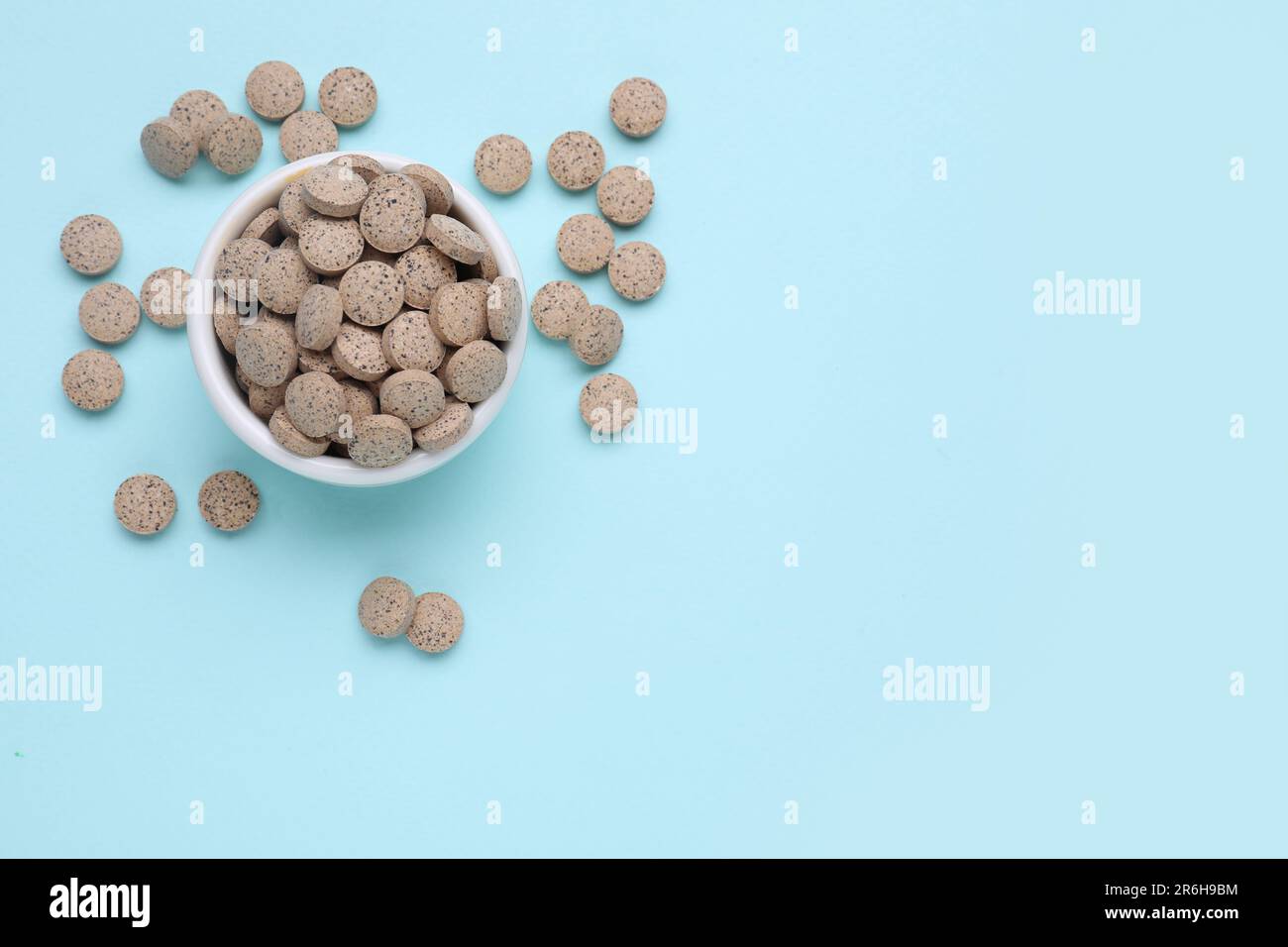 Beer yeast pills on light blue background, flat lay. Space for text ...