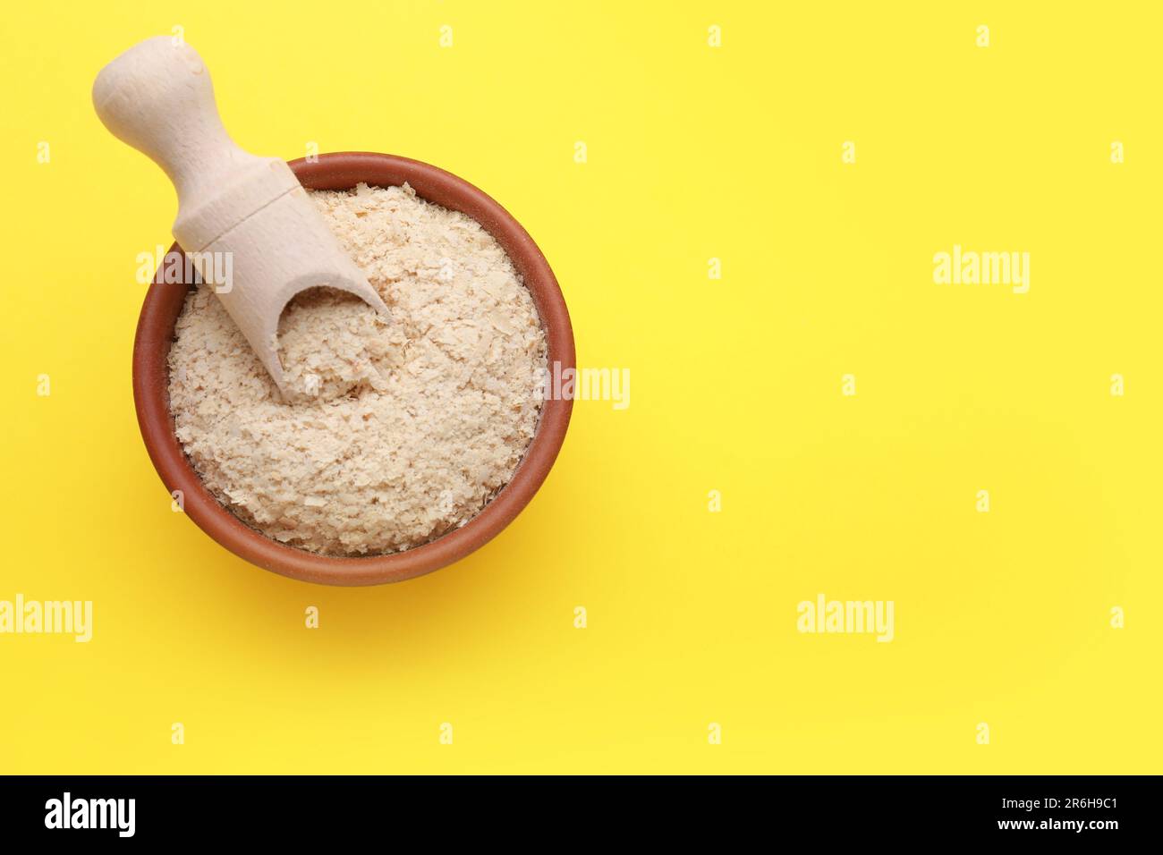 Beer yeast flakes on yellow background, top view. Space for text Stock ...