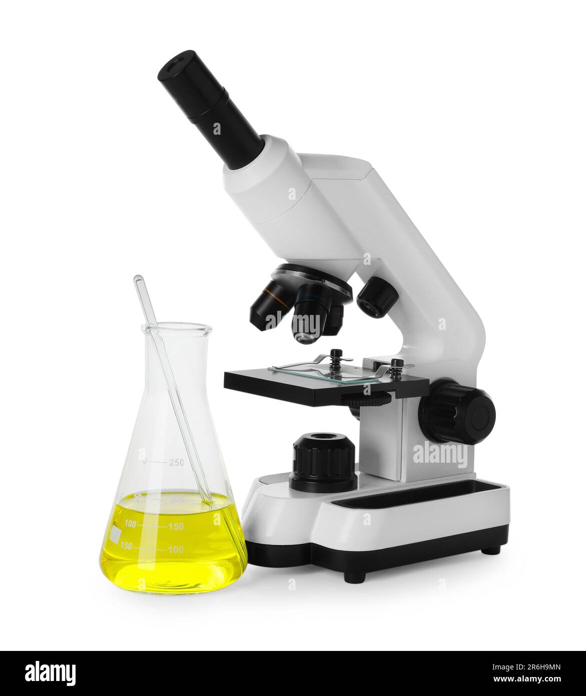 Laboratory flask with yellow liquid and microscope isolated on white ...