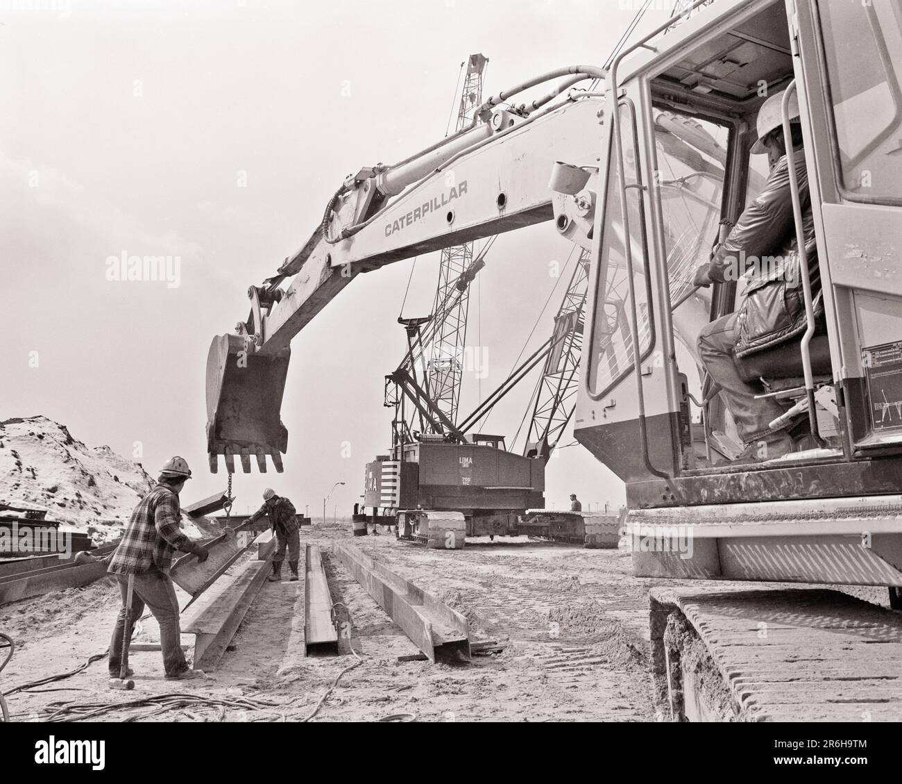 1980s THREE UNIDENTIFIED CONSTRUCTION WORKERS MOVING STEEL BEAMS USING ...