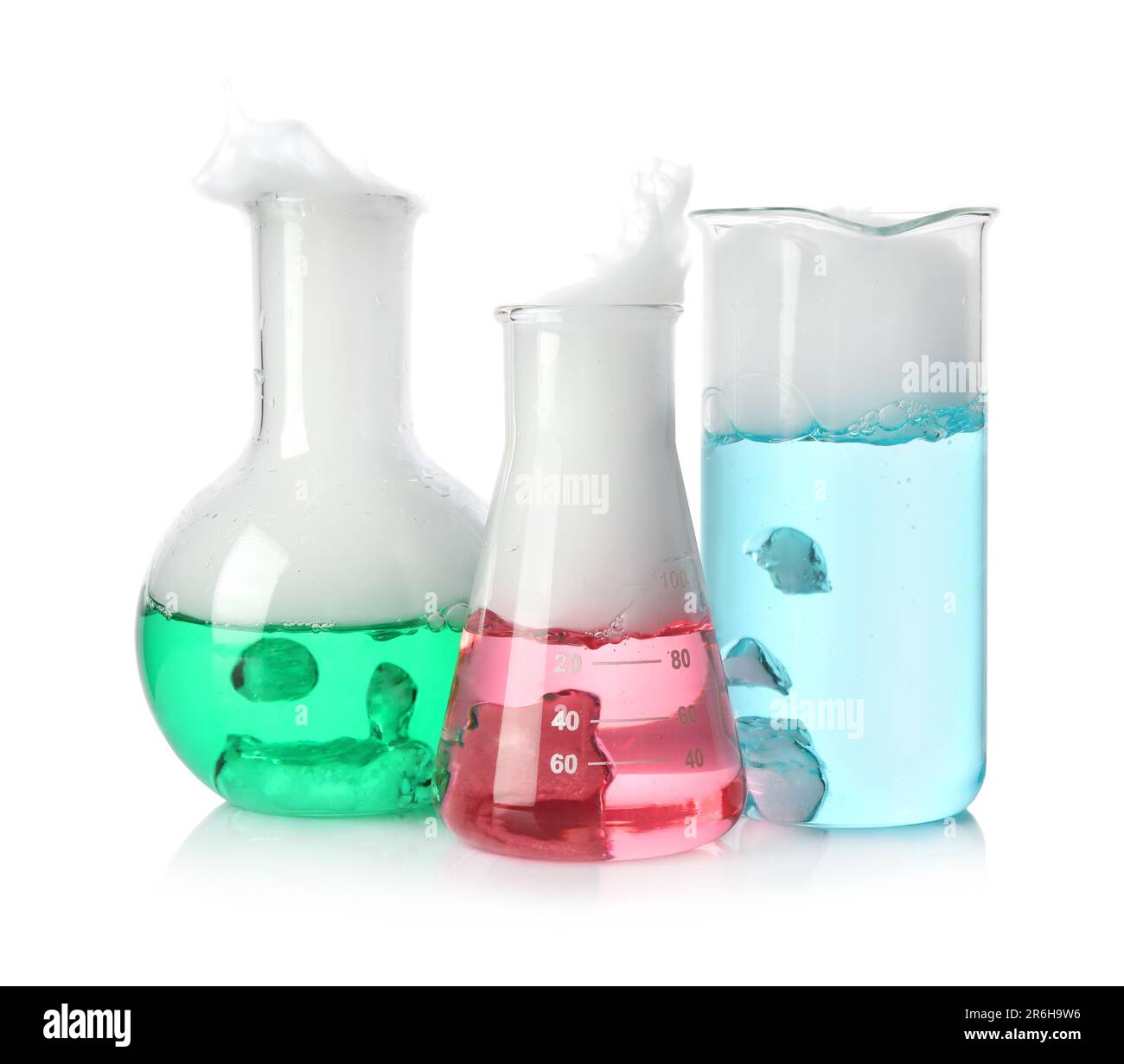 Laboratory glassware with colorful liquids and steam isolated on white ...